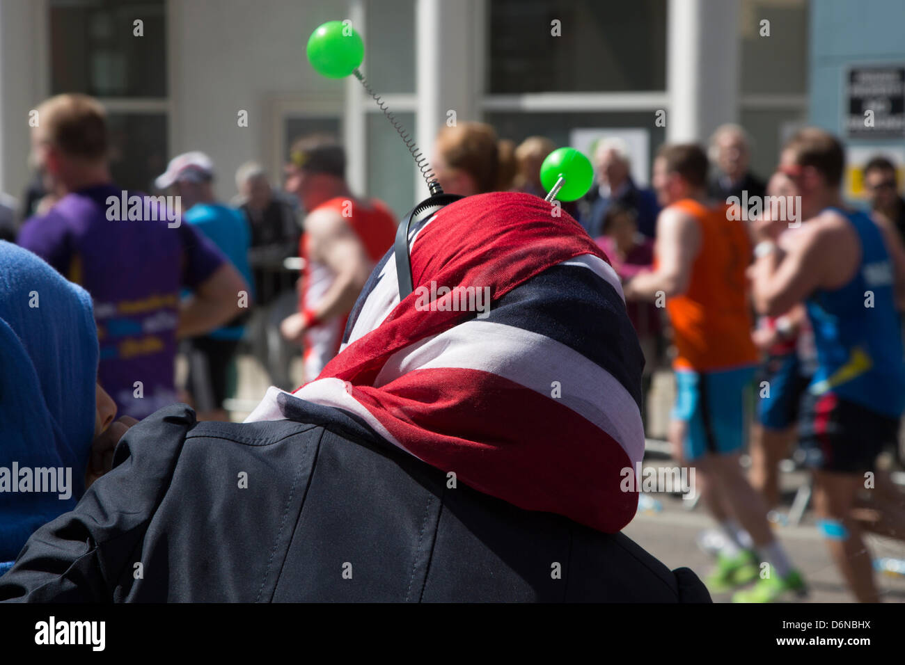 London, UK, 21 April 2013. A spectator wears head boppers over a ...