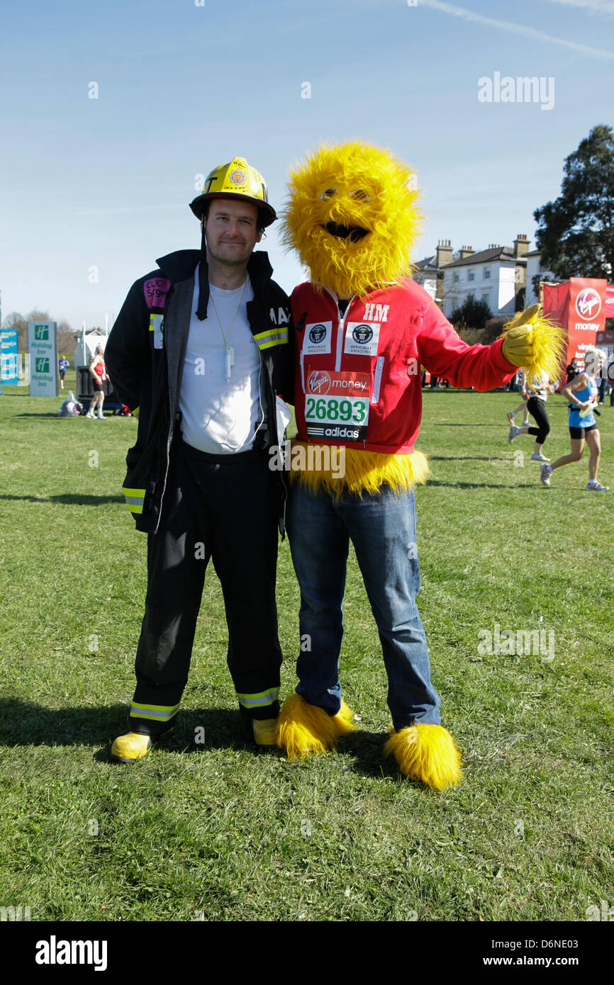 London, UK. 21st April, 2013. Runners in a fireman and furry animal ...