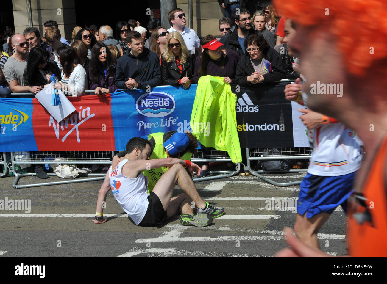 Westminster, London, UK. 21st April 2013. A runner collapses after 25 ...