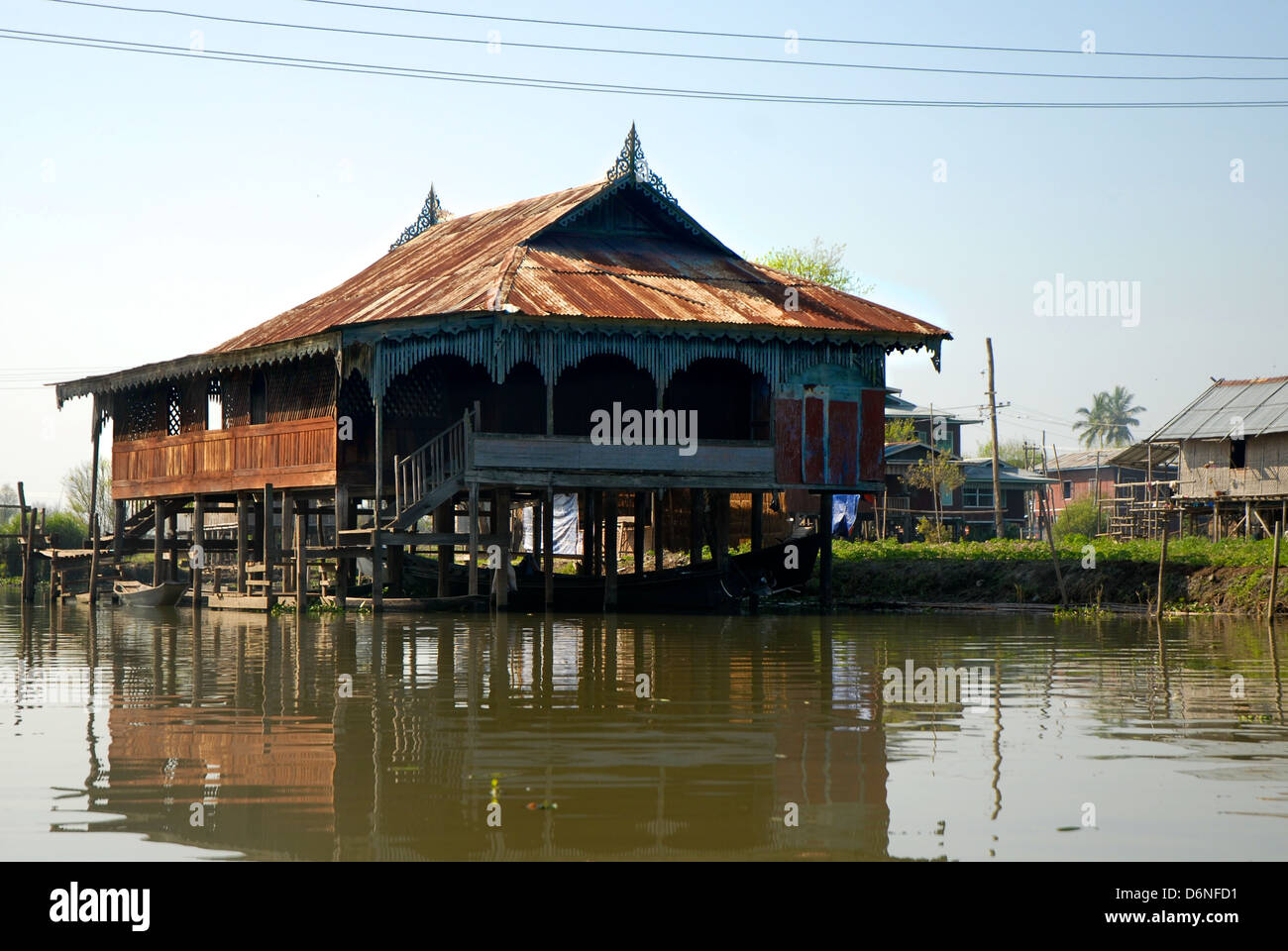 Traditional Myanmar Inle lake building, built on stilts over water with ...