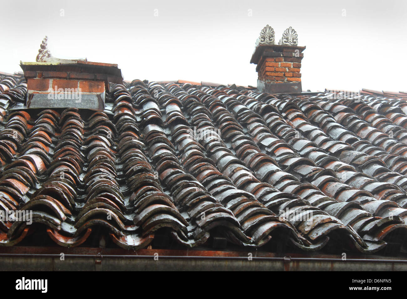 Roof under rain with wet tiles Stock Photo - Alamy