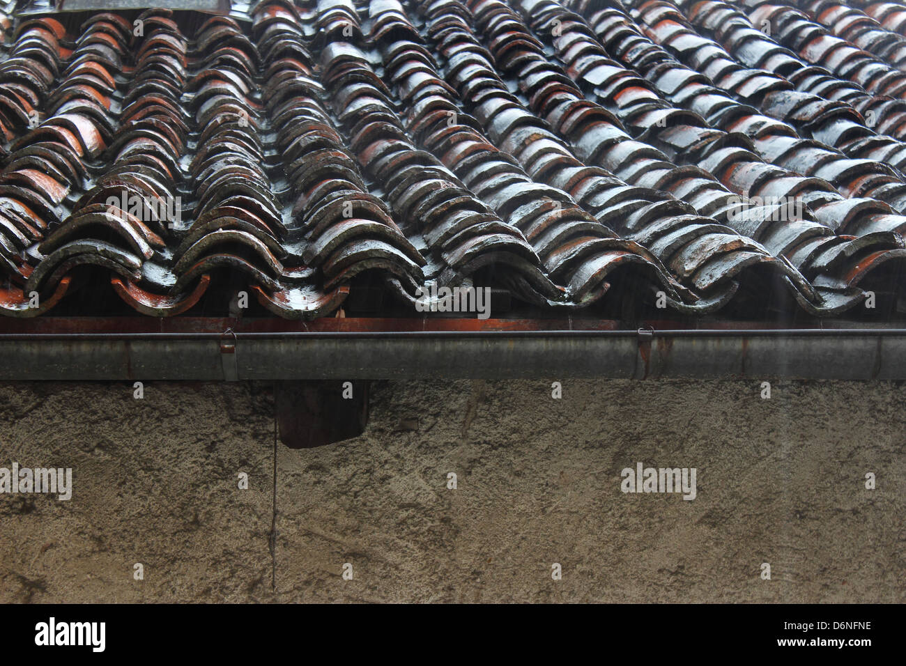 Roof under rain with wet tiles Stock Photo - Alamy
