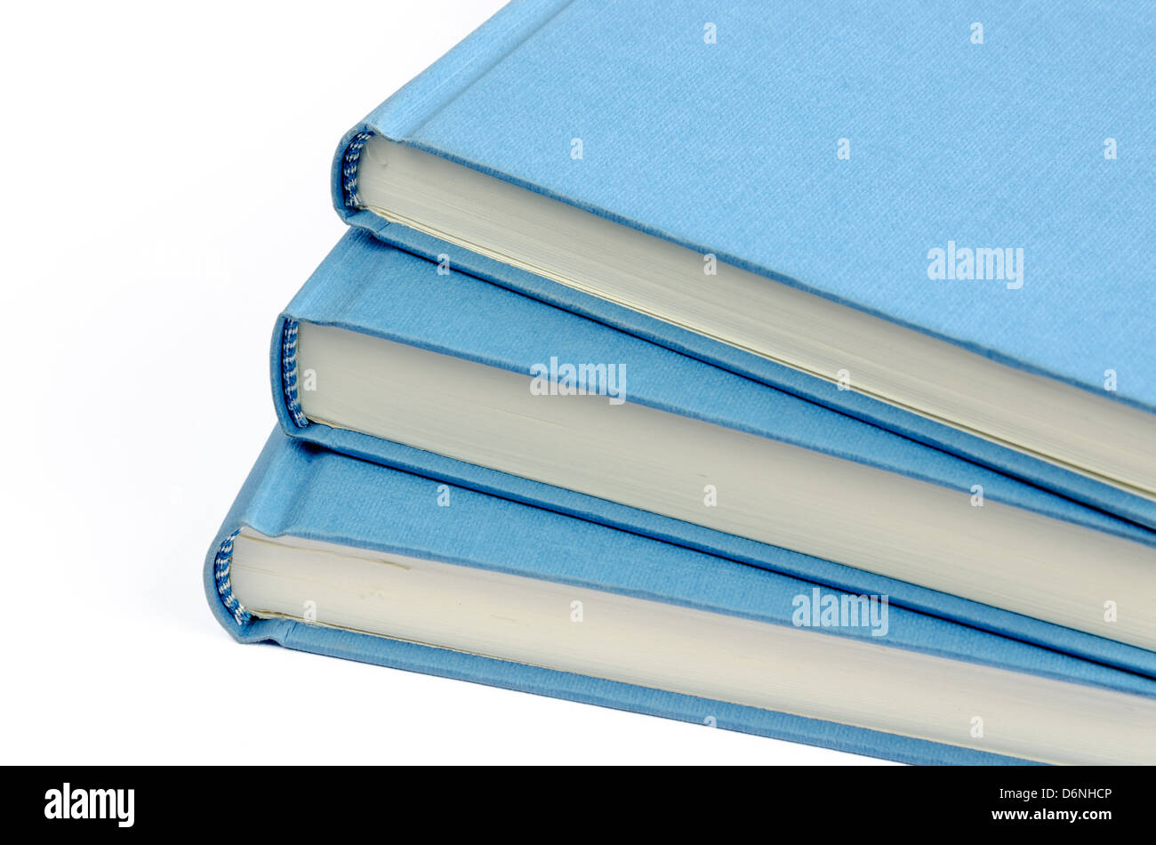 A fan of three blue books on a white background Stock Photo - Alamy