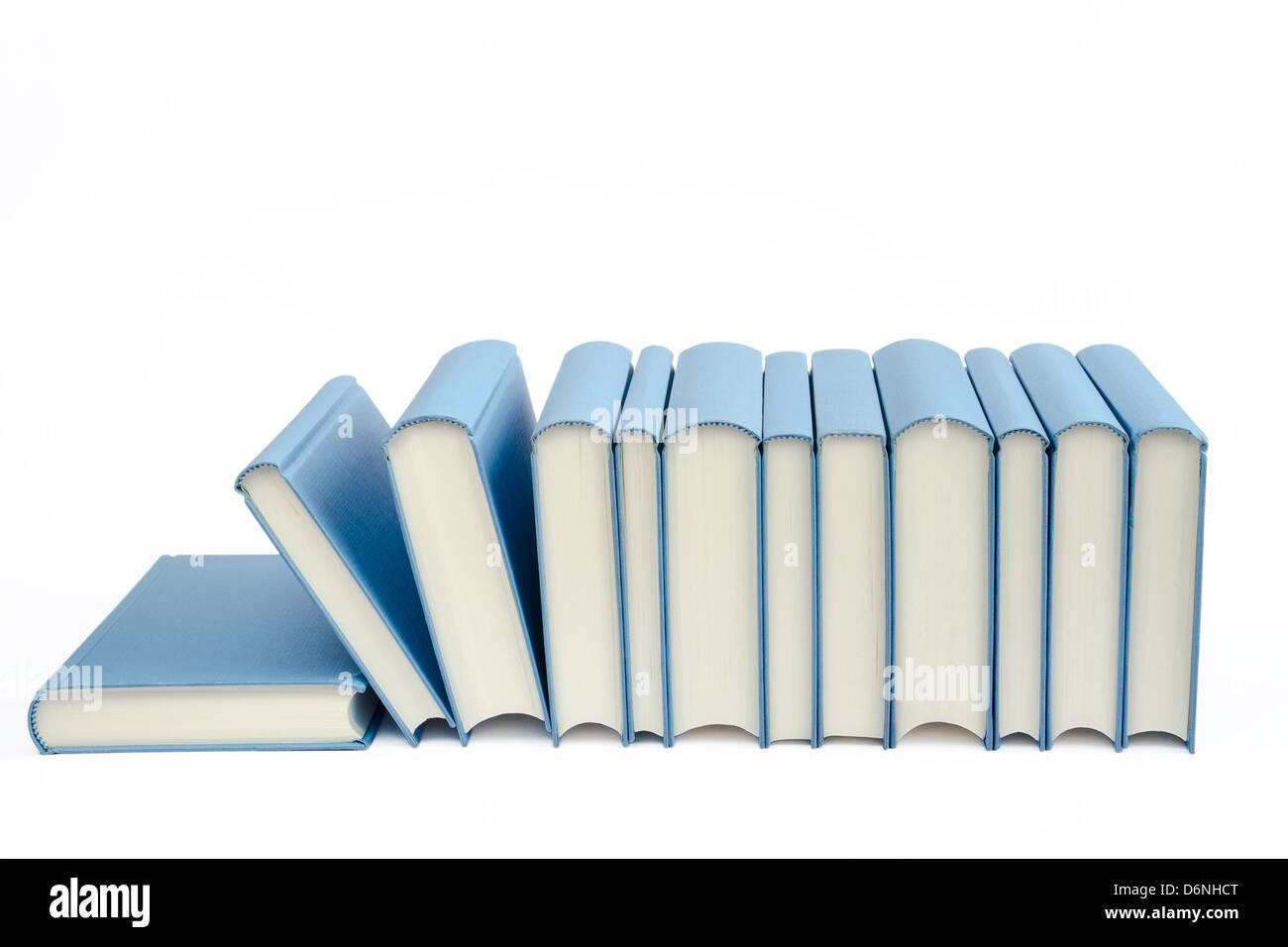 A group of blue books in a row on a white background Stock Photo - Alamy