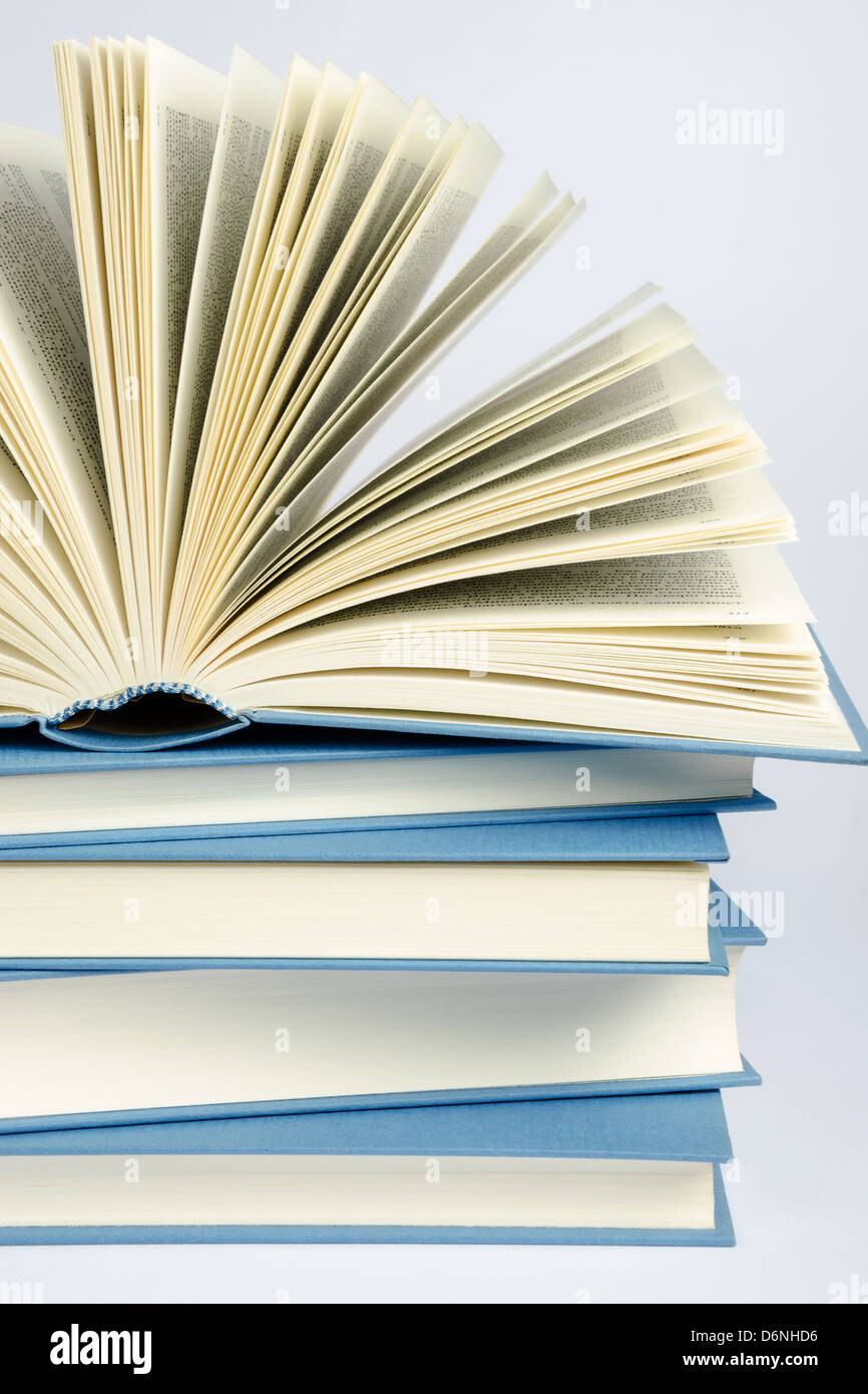 A stack of blue books on light blue background Stock Photo - Alamy