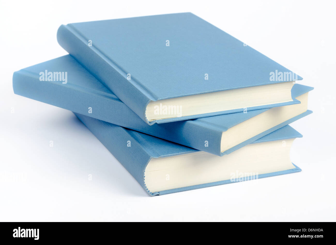 Three blue books on a white background Stock Photo - Alamy