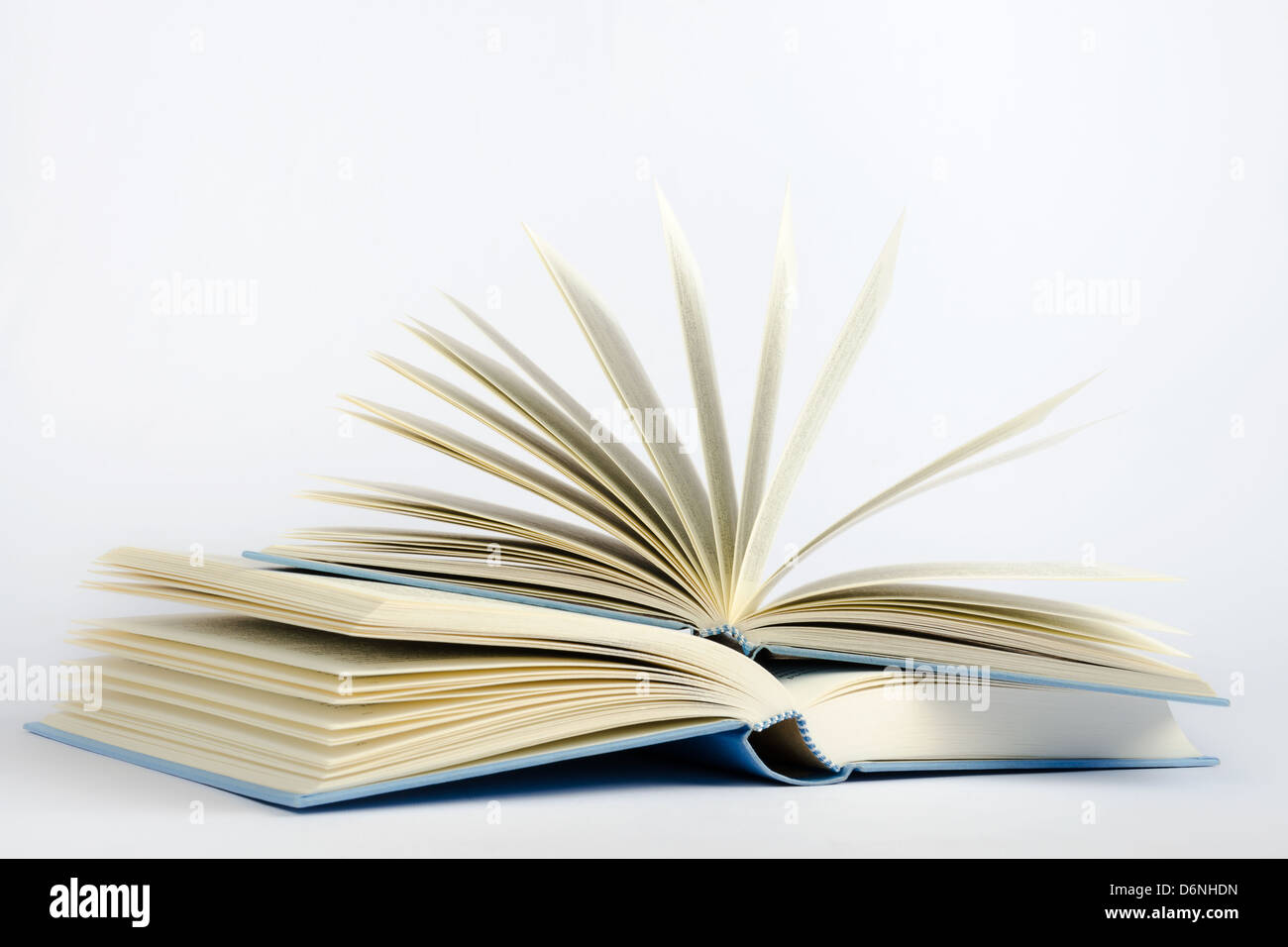 Two open blue books on a light blue background Stock Photo - Alamy