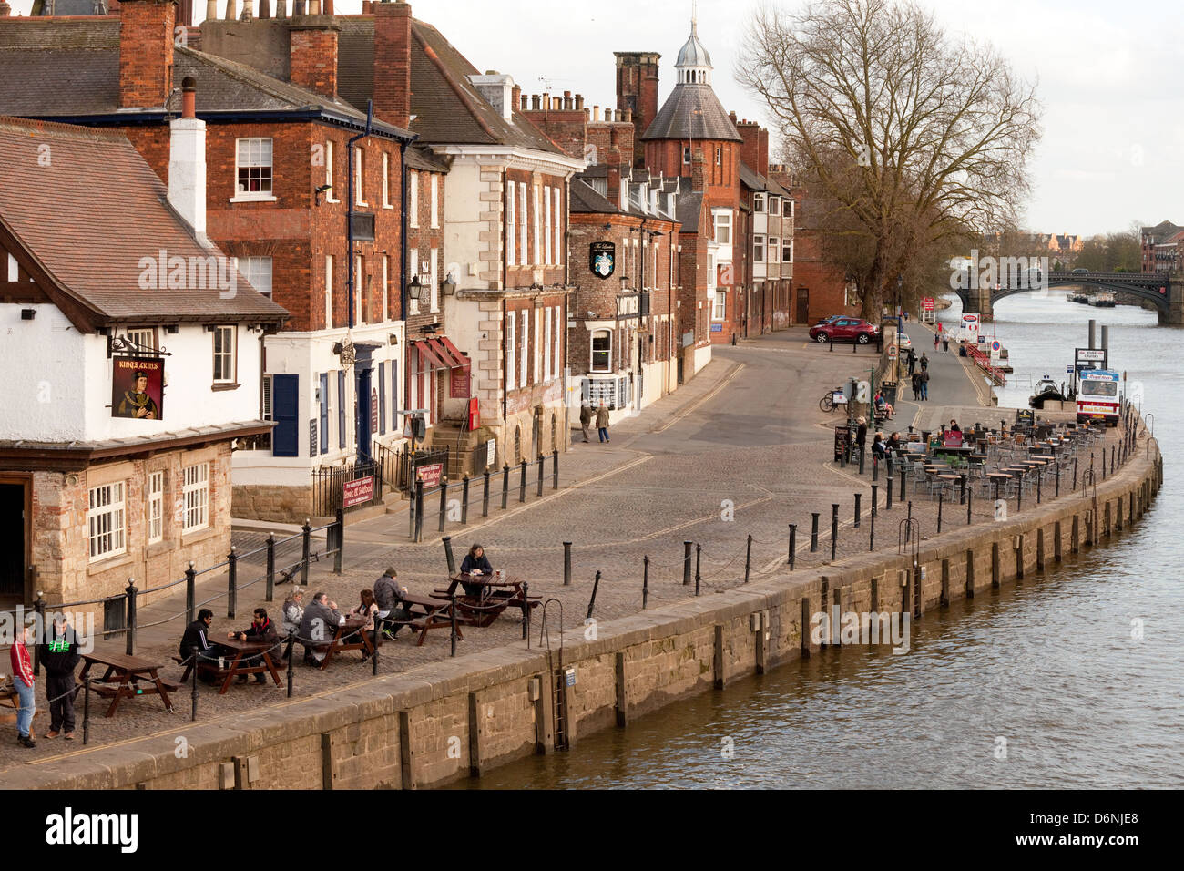 People sitting outside the Kings Arms and Lowther pubs, the river Ouse ...