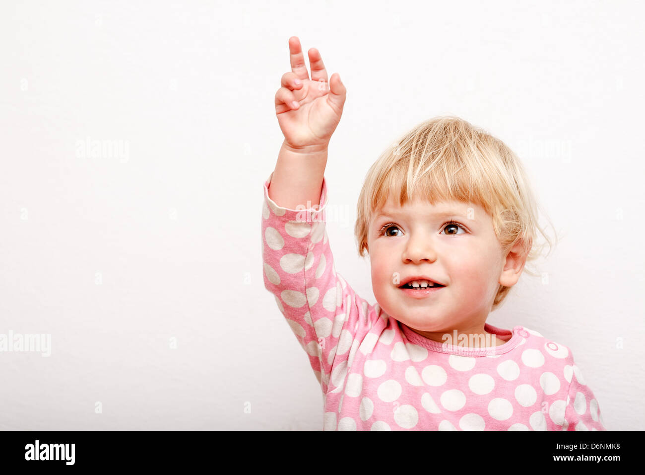 portrait of little girl raising her hand Stock Photo - Alamy