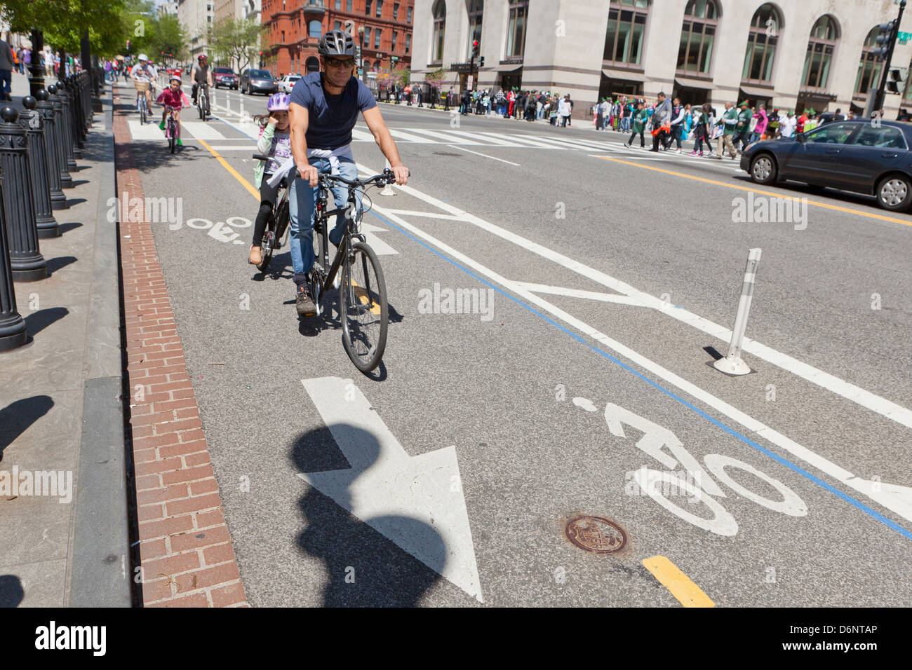 Cyclists riding in urban bike lane - Washington, DC USA Stock Photo - Alamy