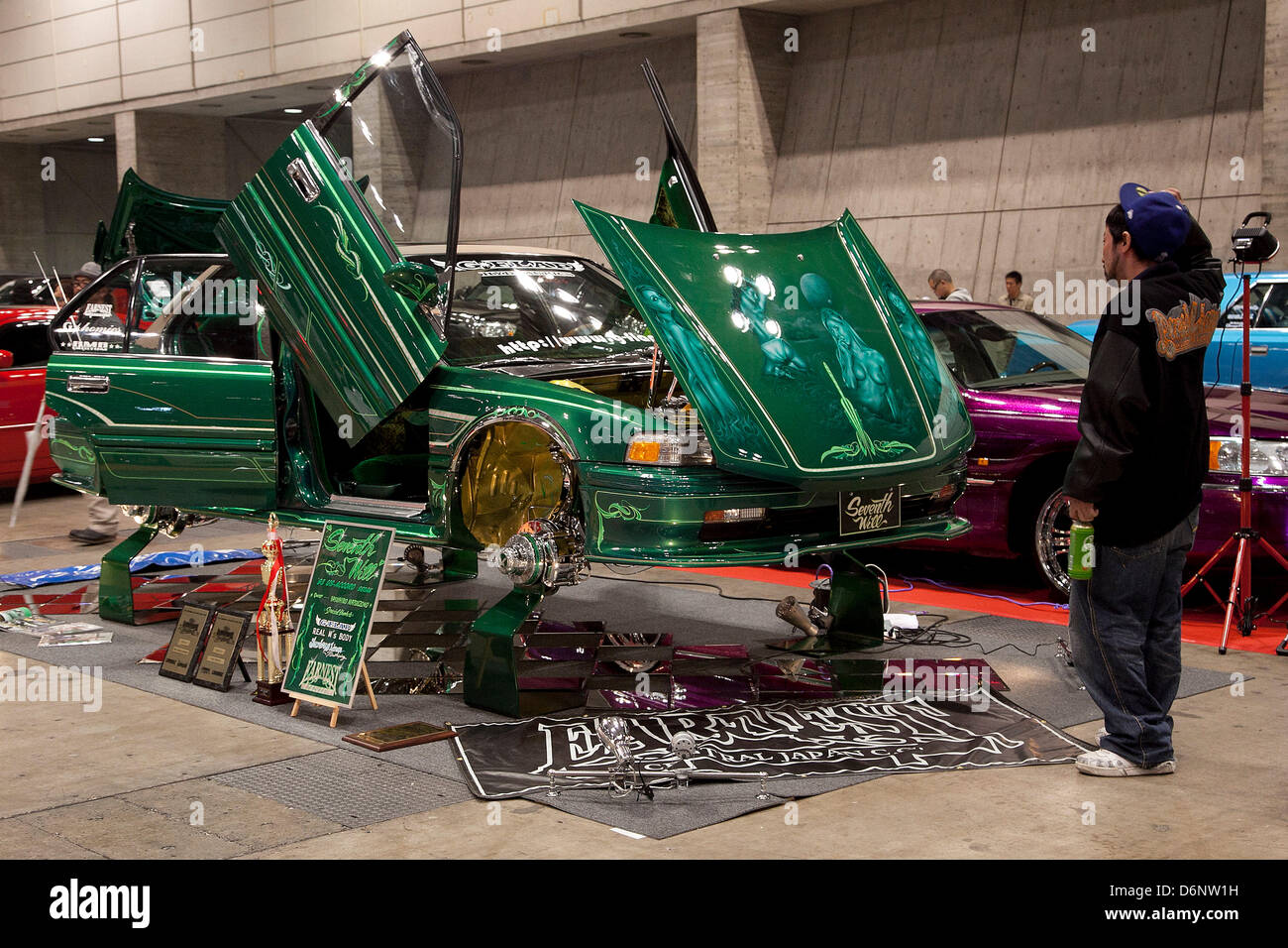 Chiba, Japan. 21st April, 2013. A visitor sees a custom car. The "New ...