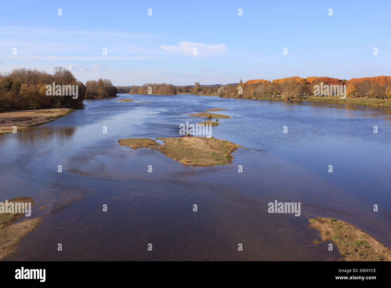 landscape of a wild river with islands and sand bordered by trees in ...