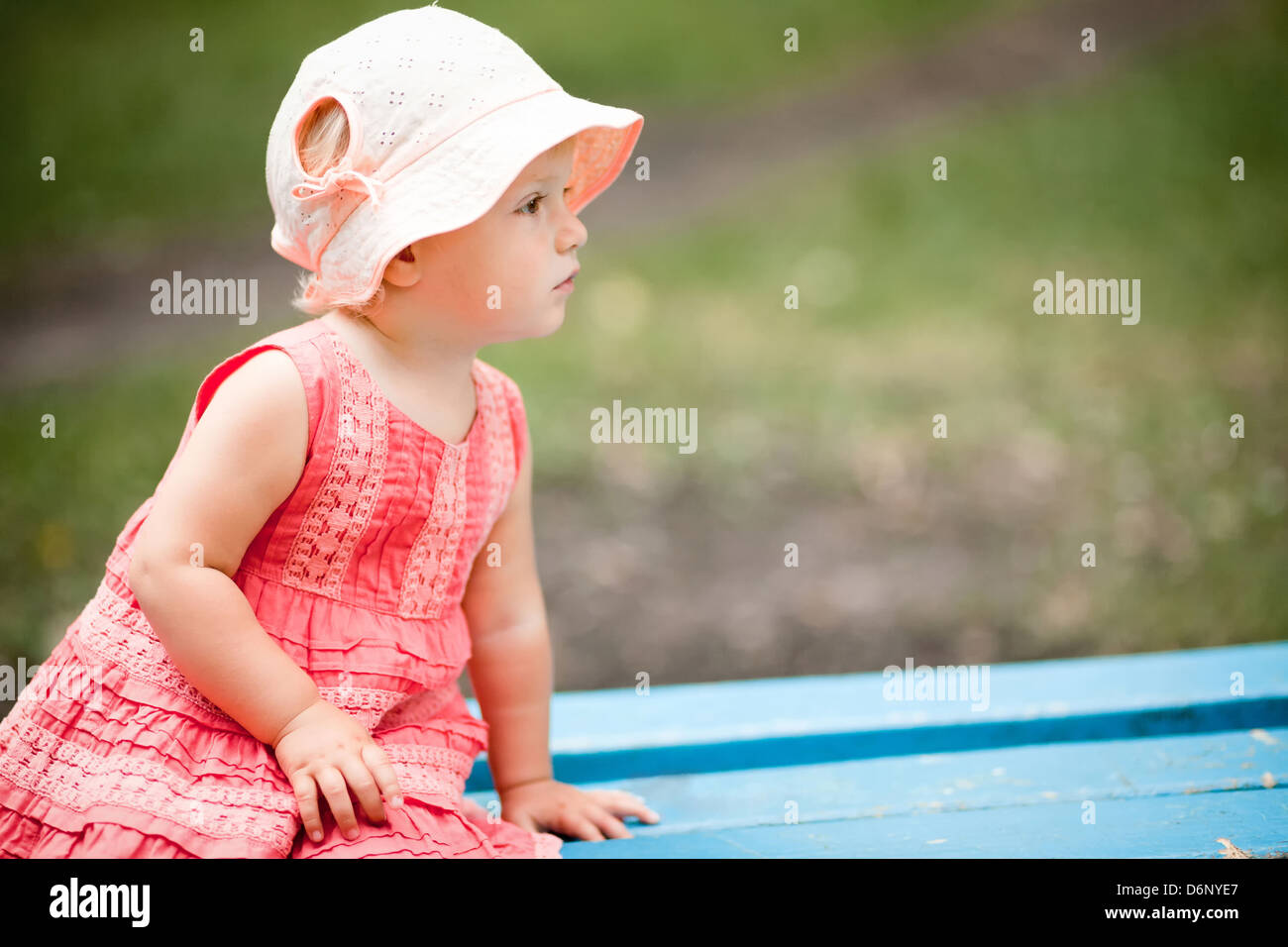 Little Girl on Park Bench Stock Photo - Alamy