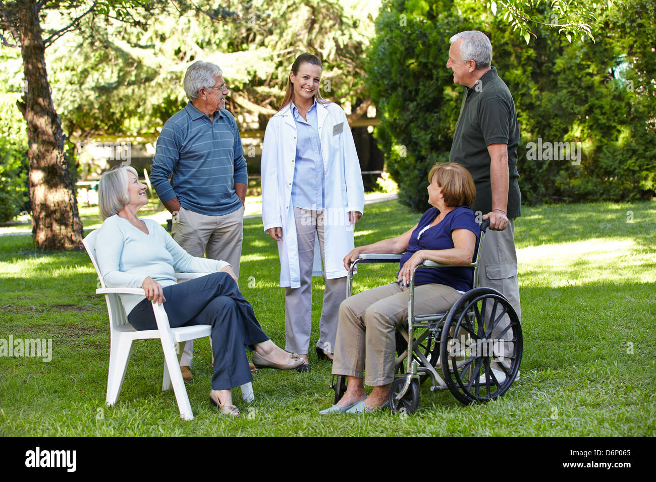 Geriatric nurse with senior group in garden of a retirement home Stock ...