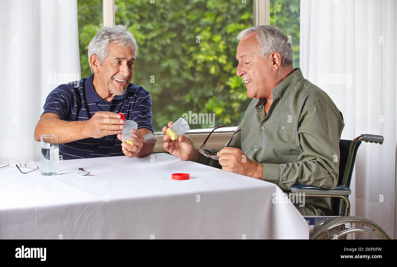 Two happy senior people taking medication in a nursing home Stock Photo ...