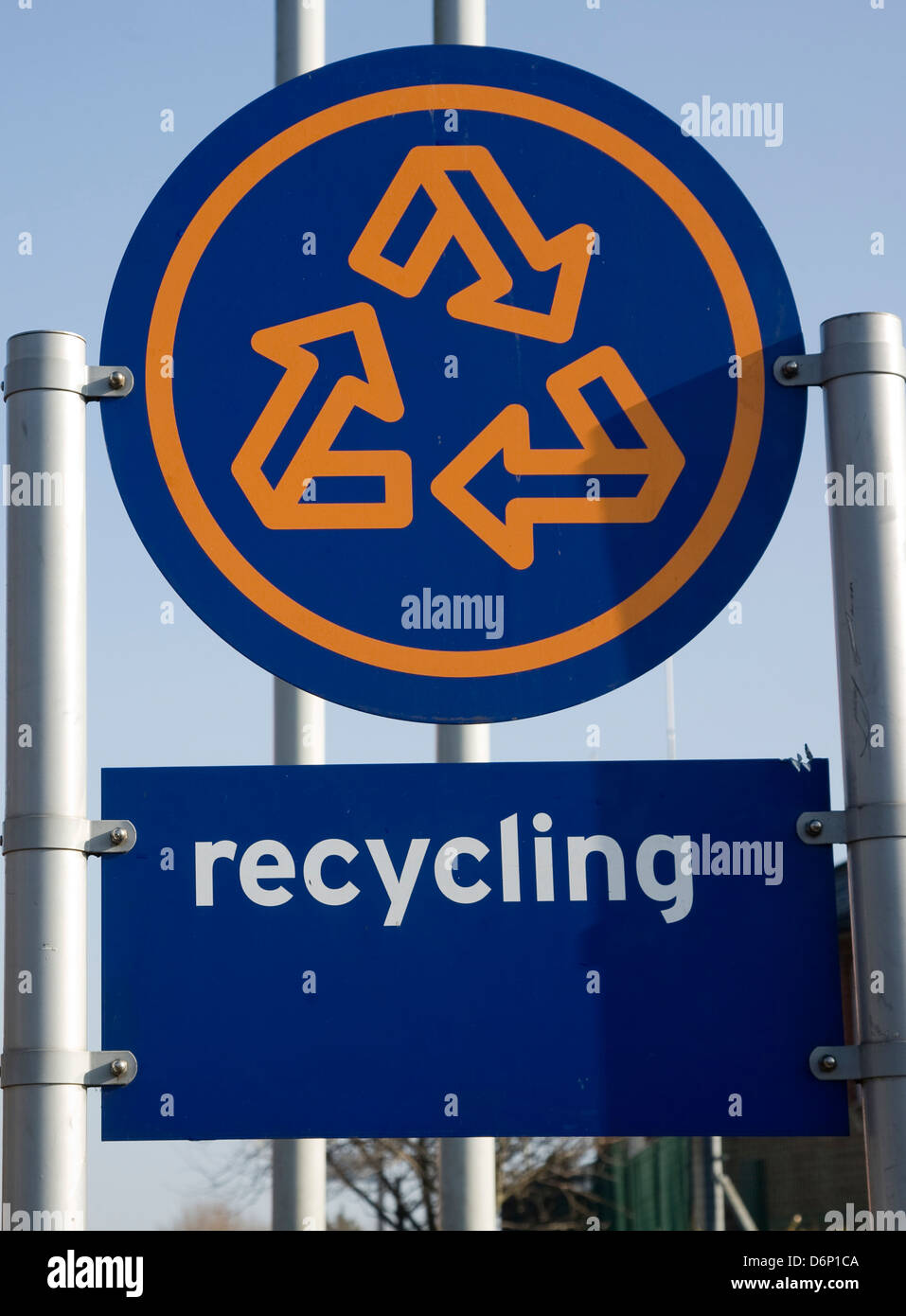 Blue and gold recycling sign against blue sky Stock Photo - Alamy