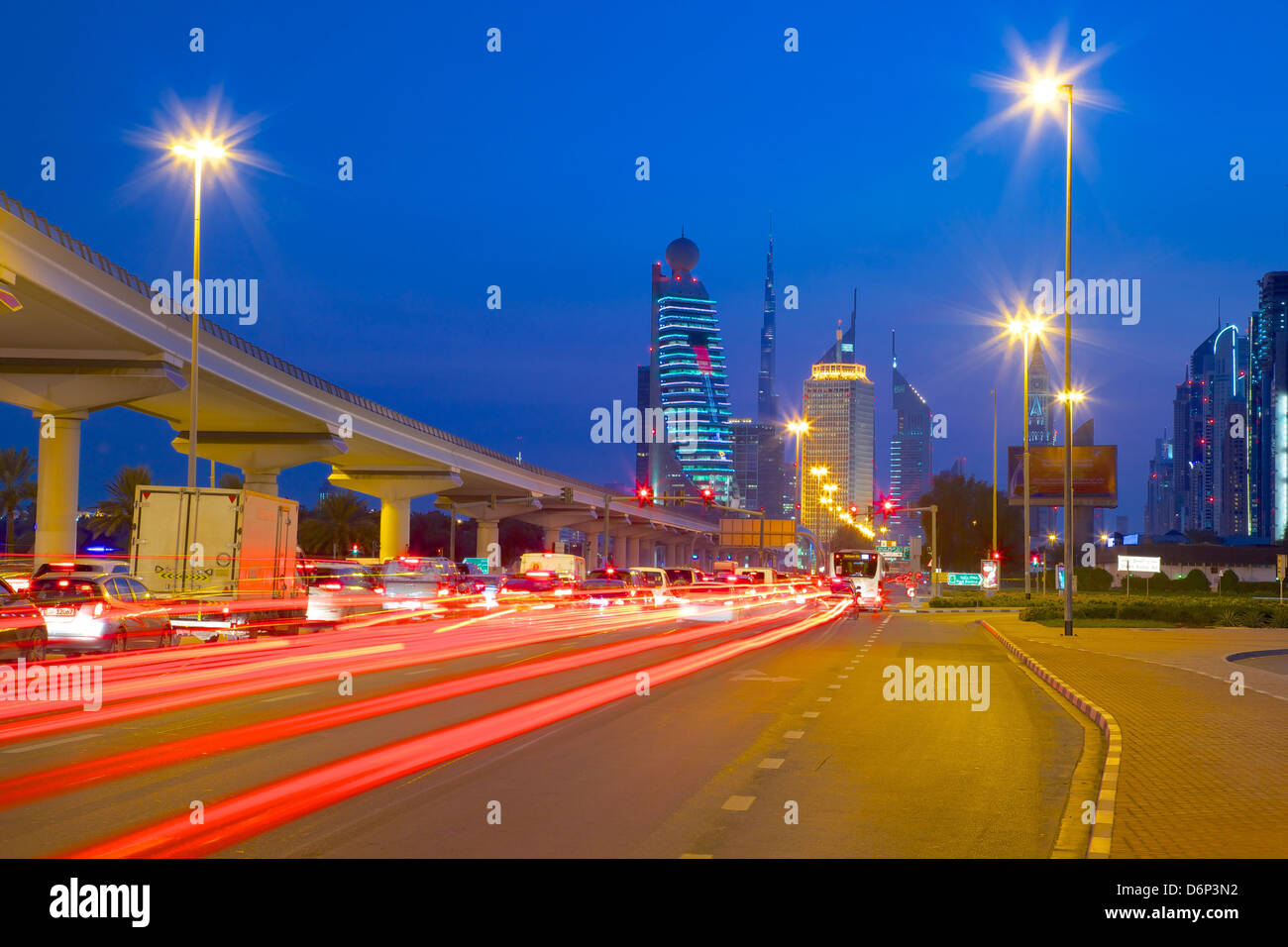 City skyline and car trail lights at sunset, Dubai, United Arab ...