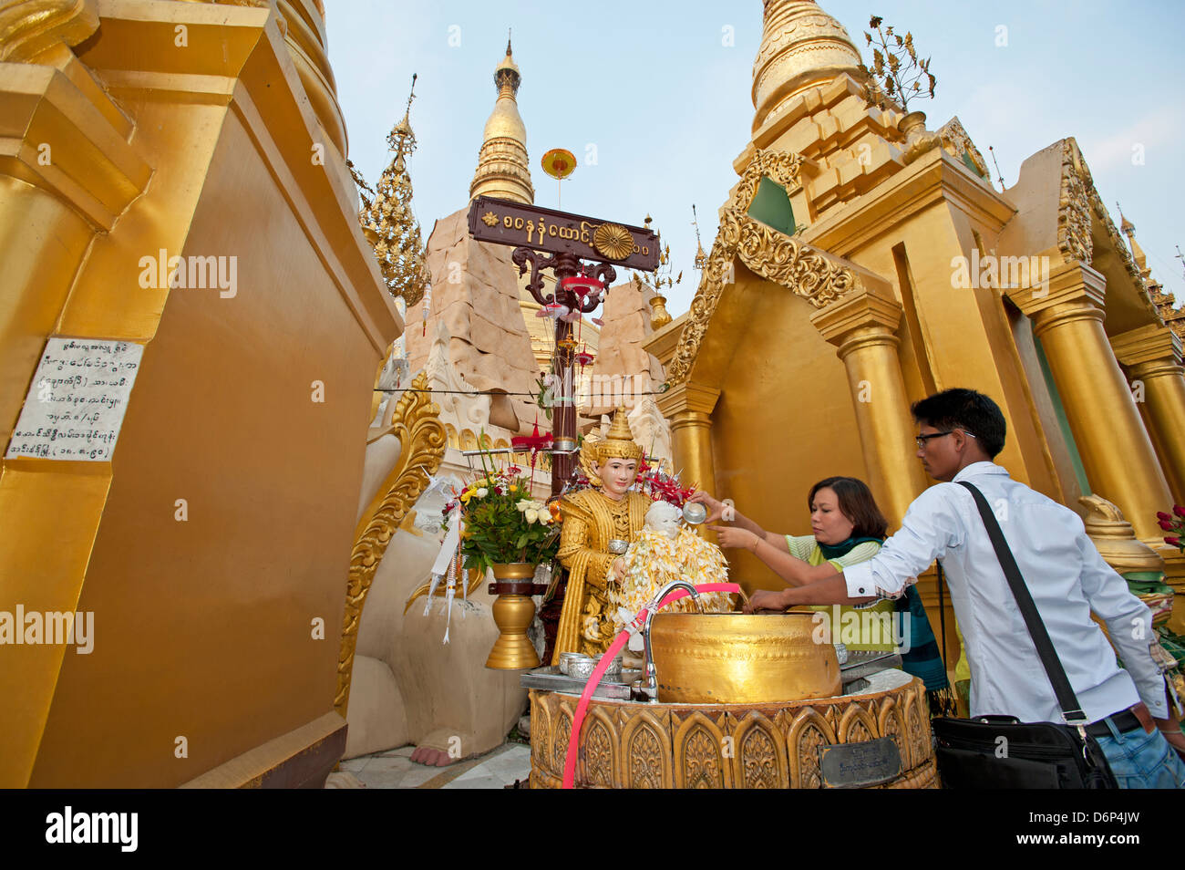 Burmese worshipers wash a Buddha at the Shwedagon Pagoda Yangon Myanmar ...