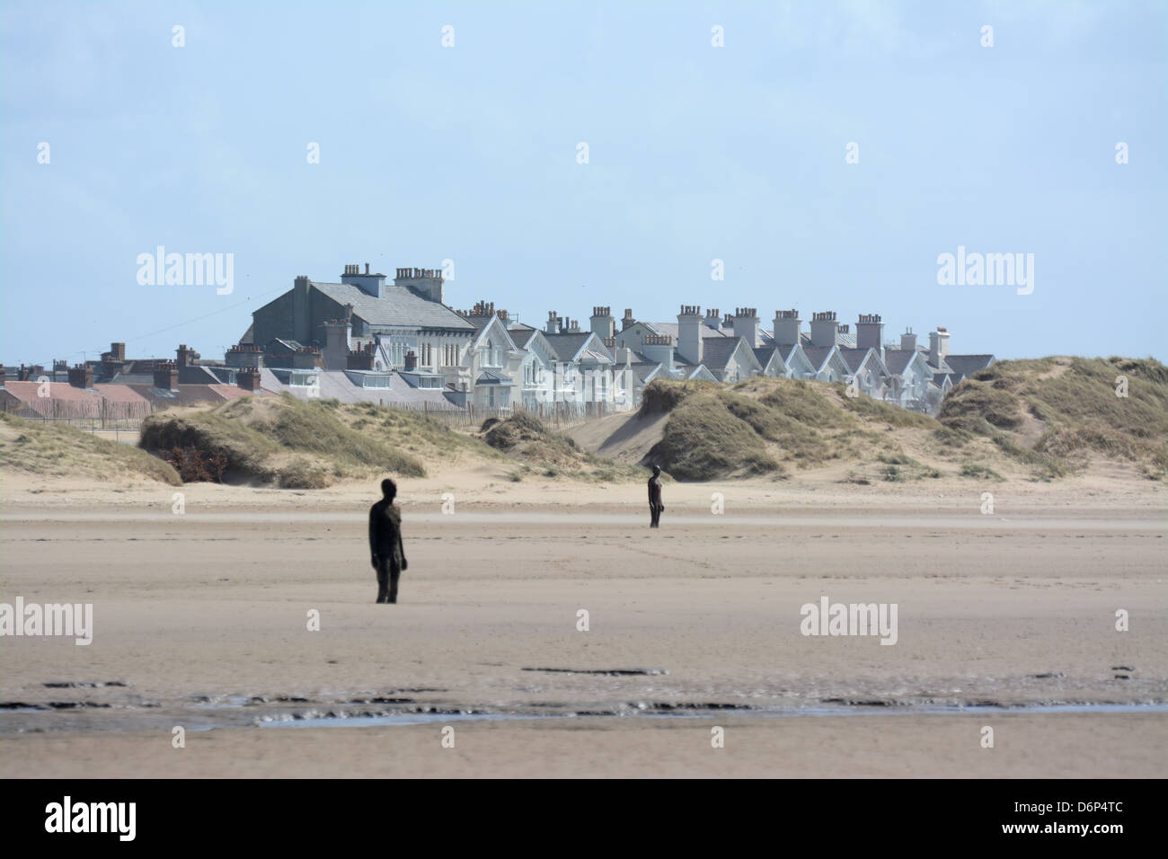 Antony Gormley's Another Place statues on the beach at Crosby with ...