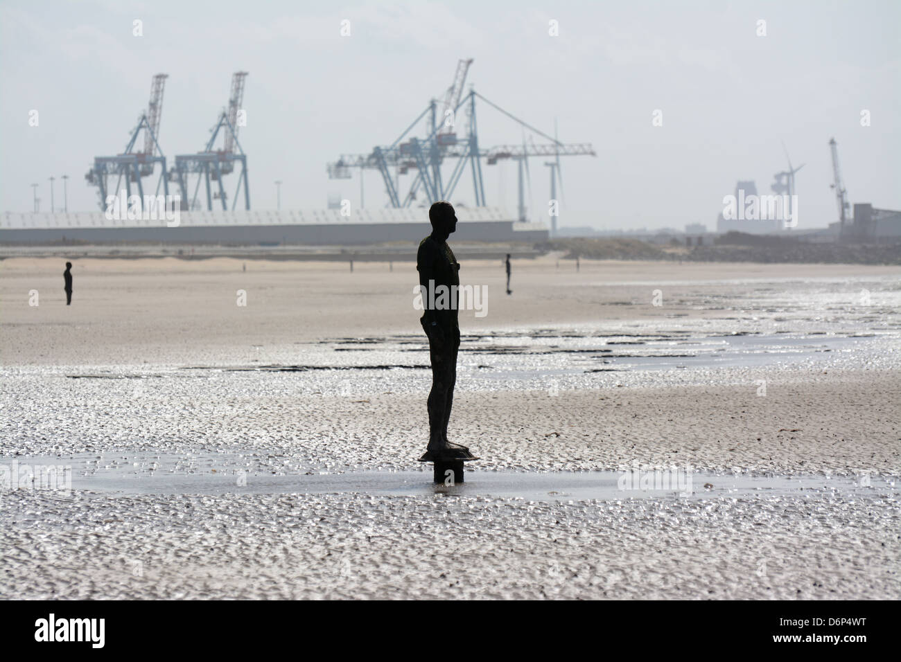Antony Gormley's Another Place statues on the beach at Crosby with ...