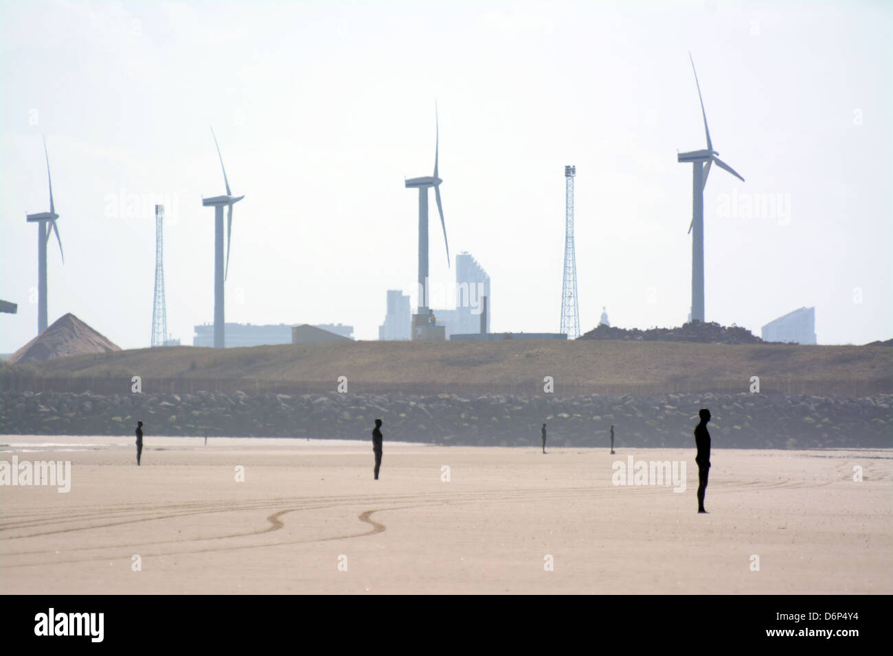 Antony Gormley's Another Place statues on the beach at Crosby with a ...