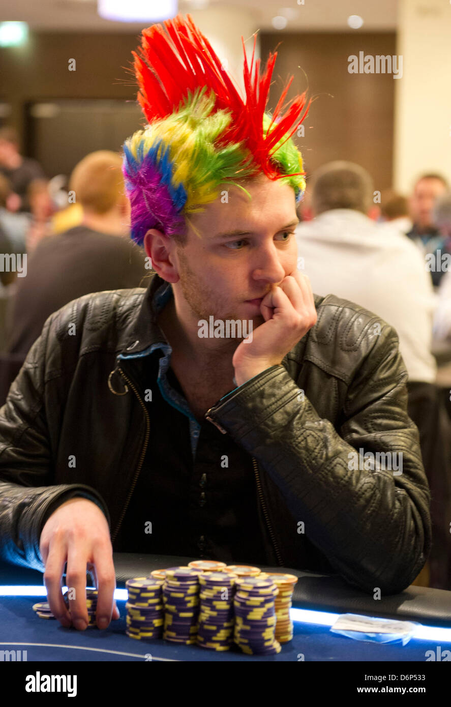 Poker player costumed as a clown sits at a table in Grand Hyatt Berlin ...