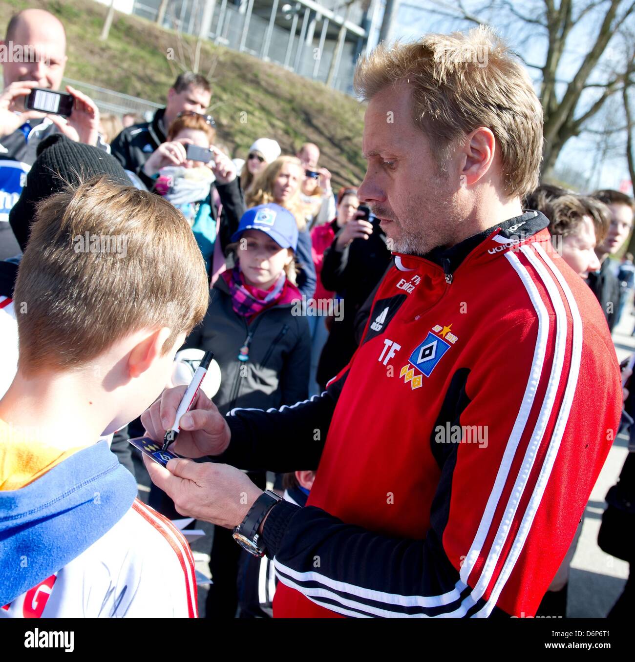 Hamburger SV coach Thorsten Fink signs autographs after training in ...