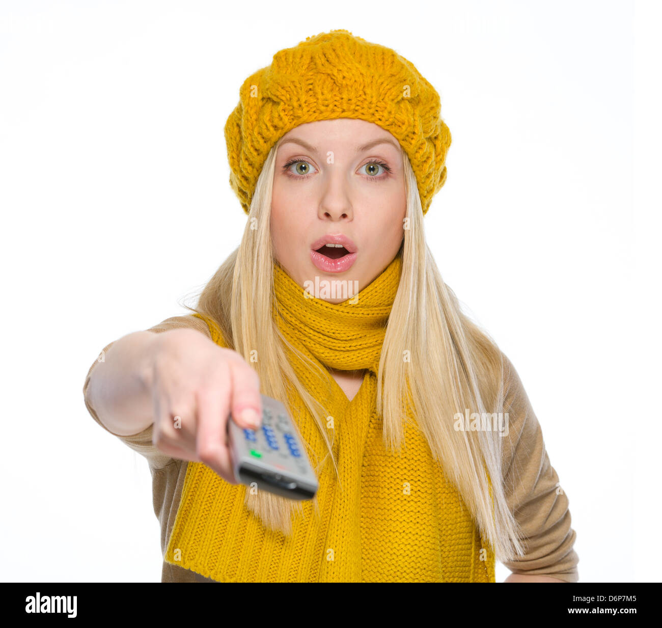 Surprised girl in autumn clothes using tv remote control Stock Photo ...