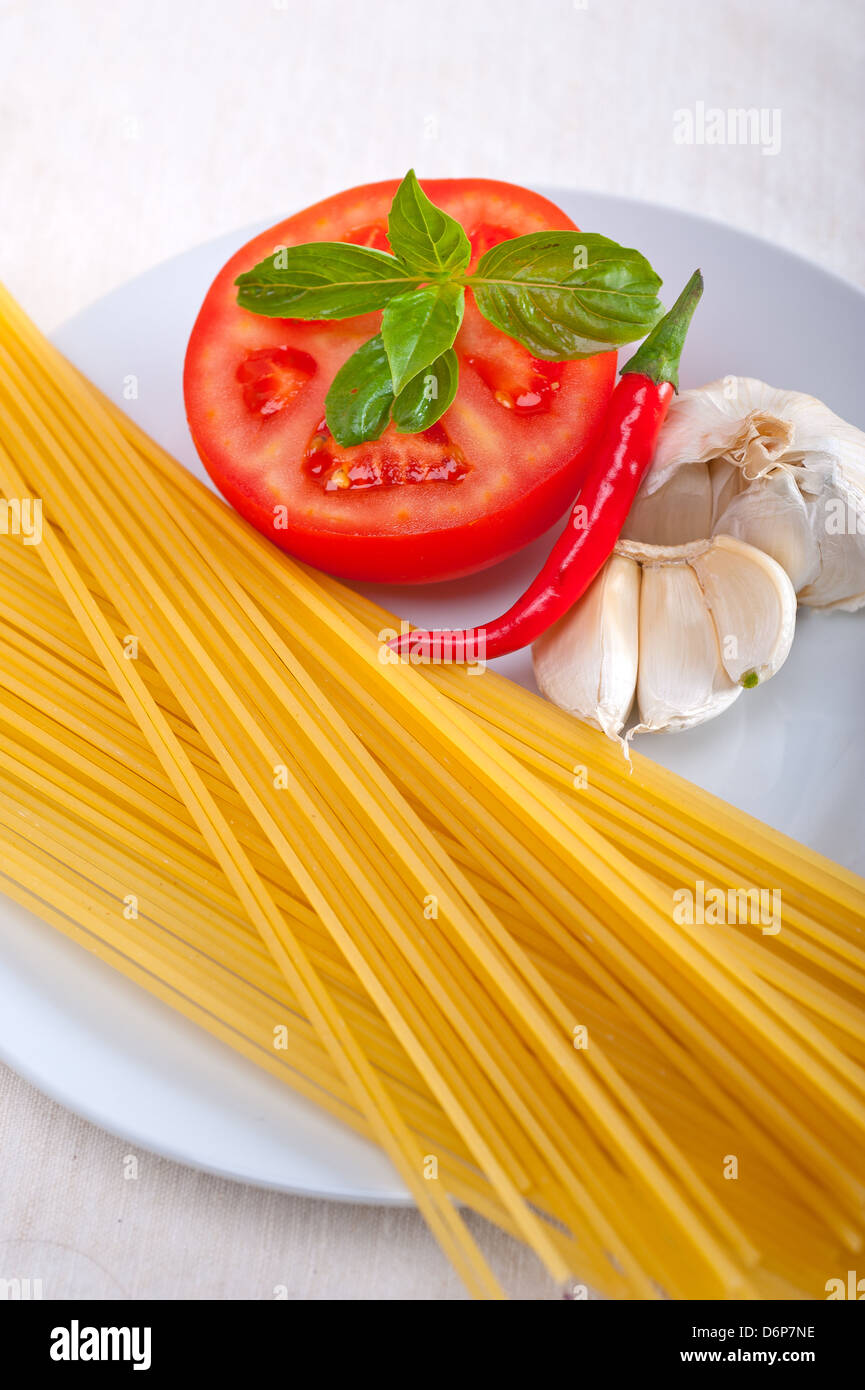 Italian spaghetti pasta tomato raw ingredients basil garlic and red ...