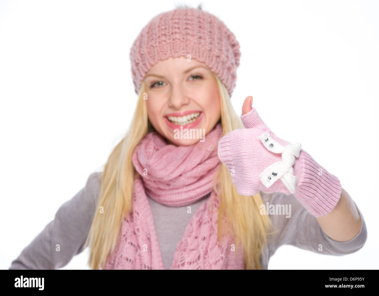 Happy girl in winter clothes showing thumbs up Stock Photo - Alamy