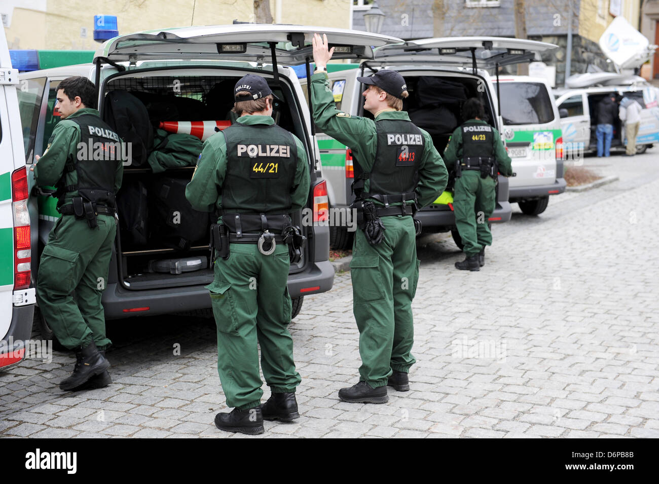 Police officers walk to a residential building where the search for ...