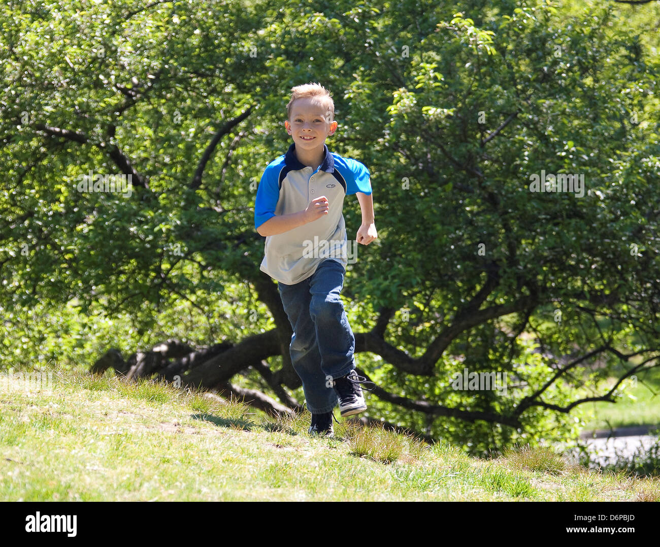 Boy running in park Stock Photo - Alamy
