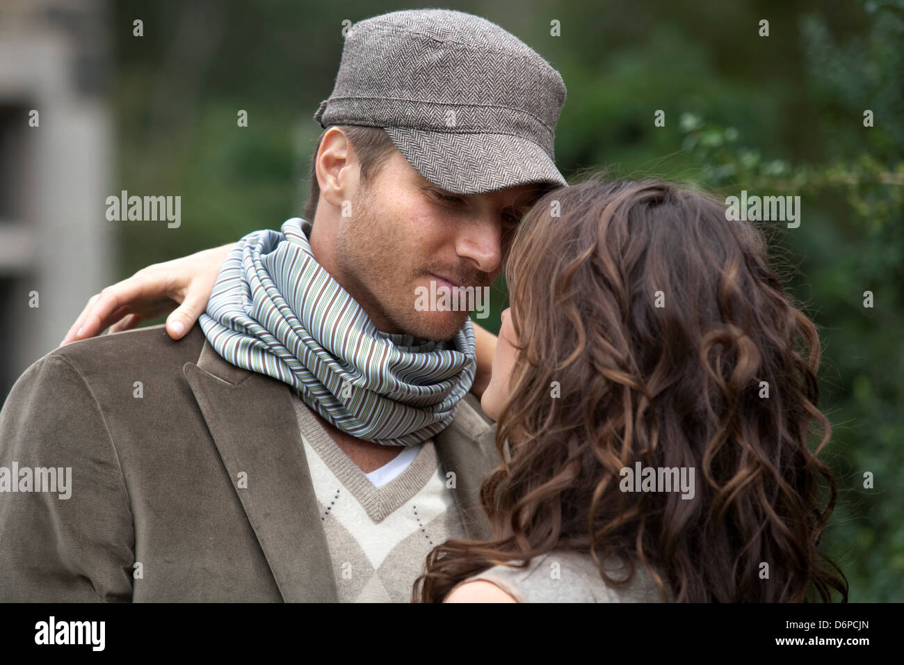 Young couple embracing in park Stock Photo - Alamy