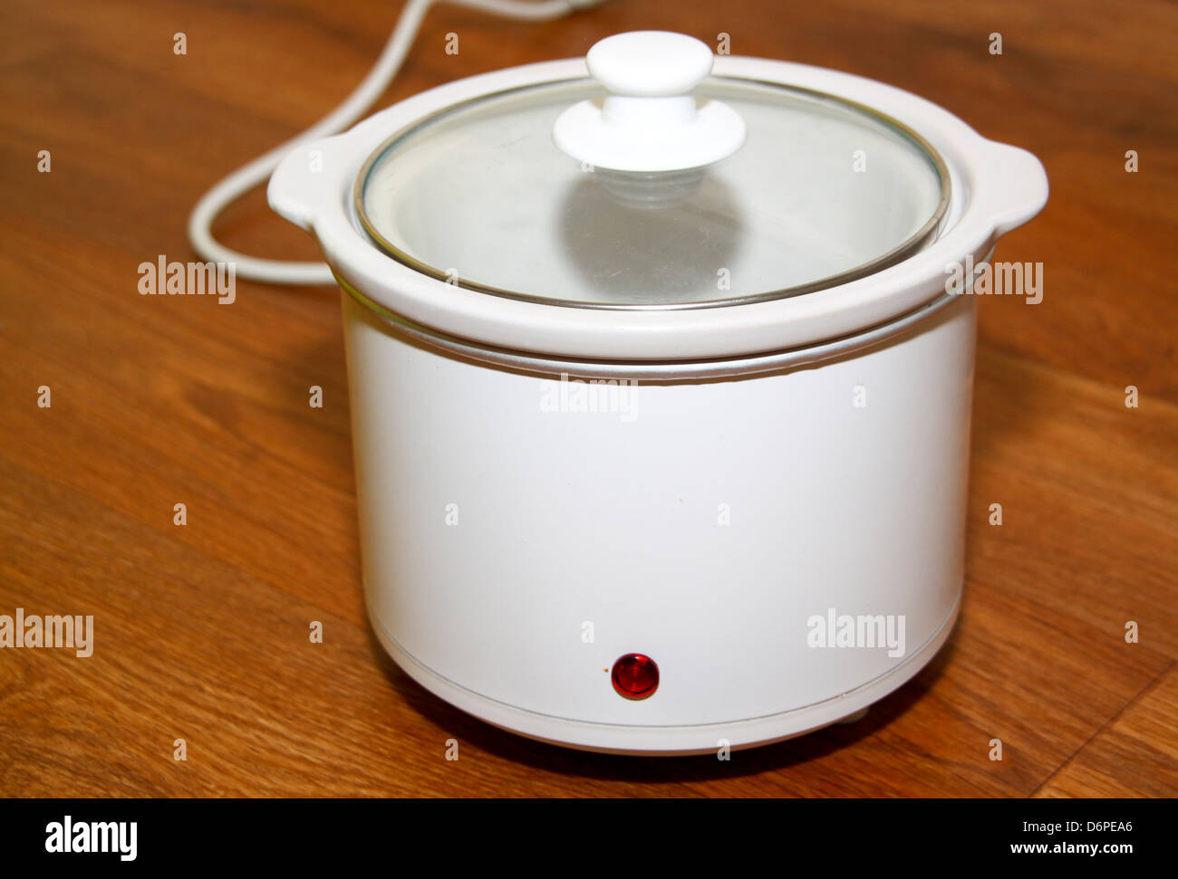 Small white electric slow cooker Stock Photo - Alamy