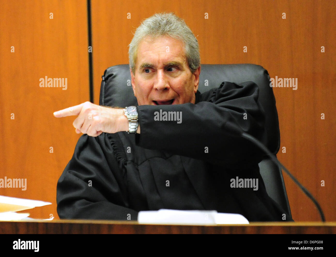 Judge Michael E. Pastor instructs the defense counsel to return to his ...