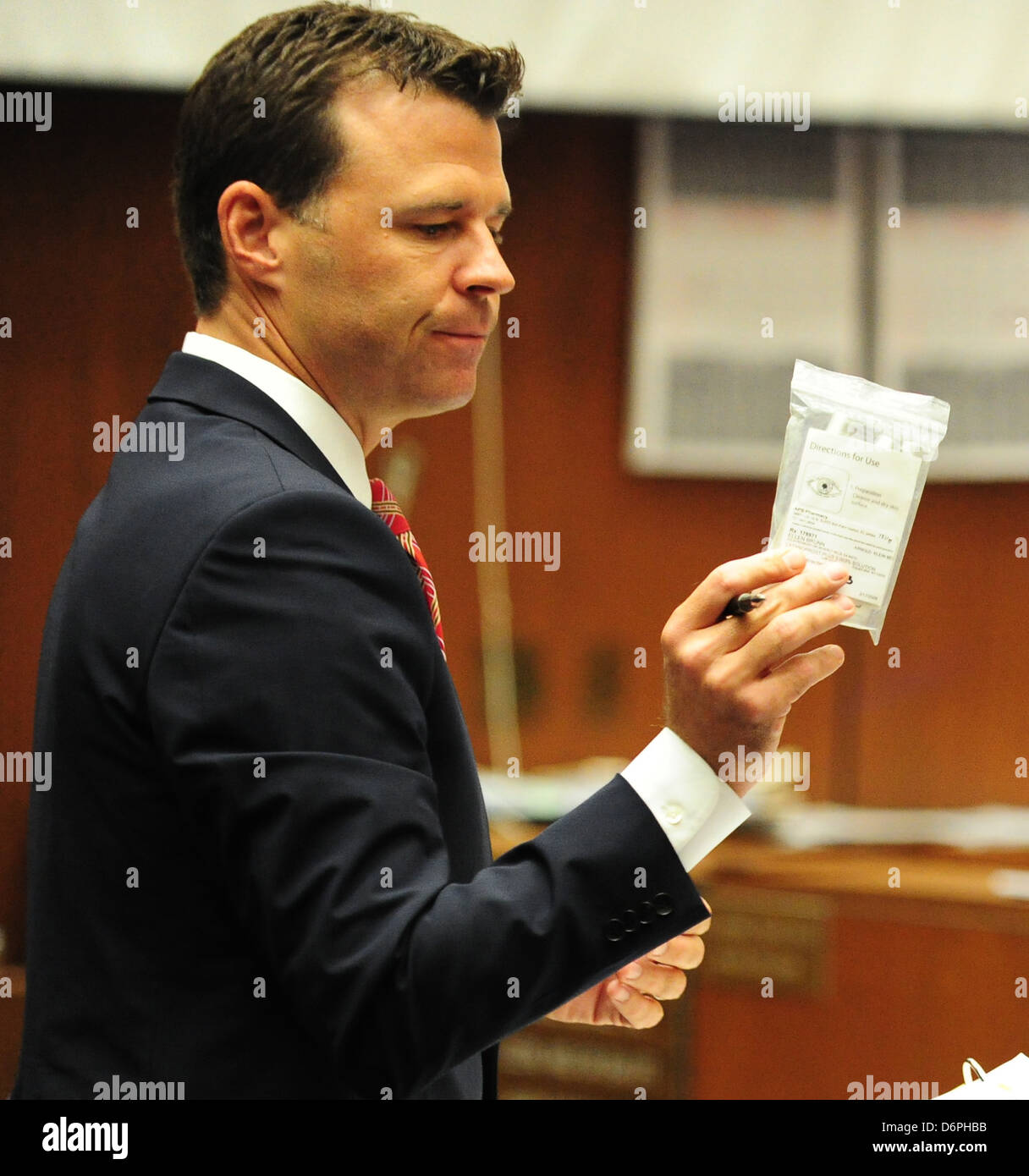 Deputy District Attorney David Walgren holds up a plastic bag with a ...