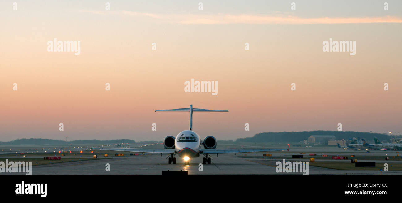 An airplane taxis down the runway before takeoff Stock Photo - Alamy