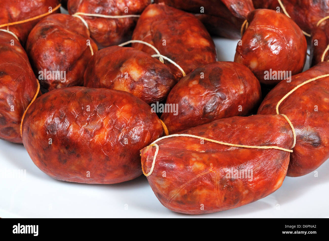 String of Spanish Chorizo sausage on a white plate, Andalucia, Spain ...