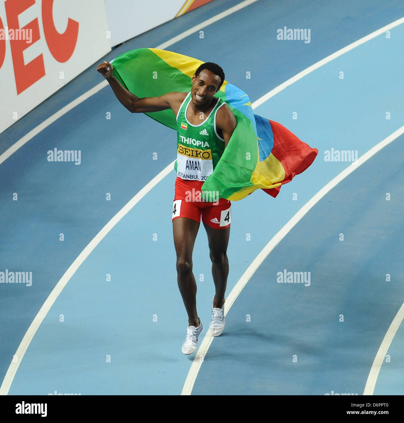 Ethiopia's Mohammed Aman celebrates with a national flag after winning ...