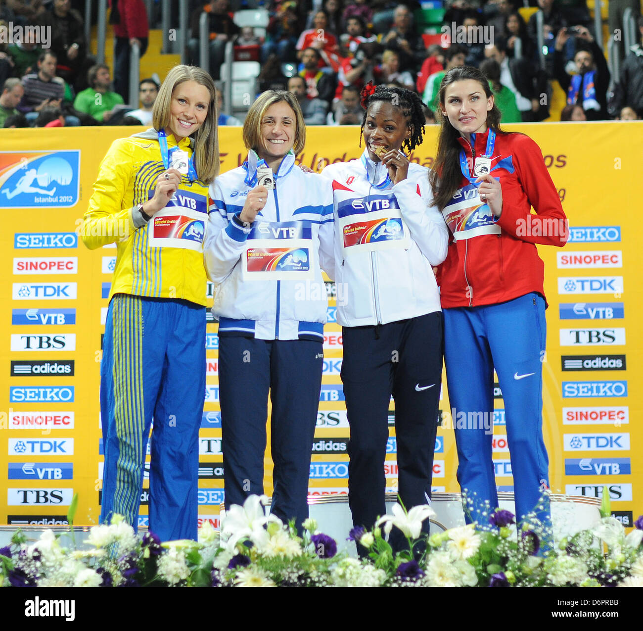 US gold medal winner athlete Chaunte Lowe (2R) poses with the three ...