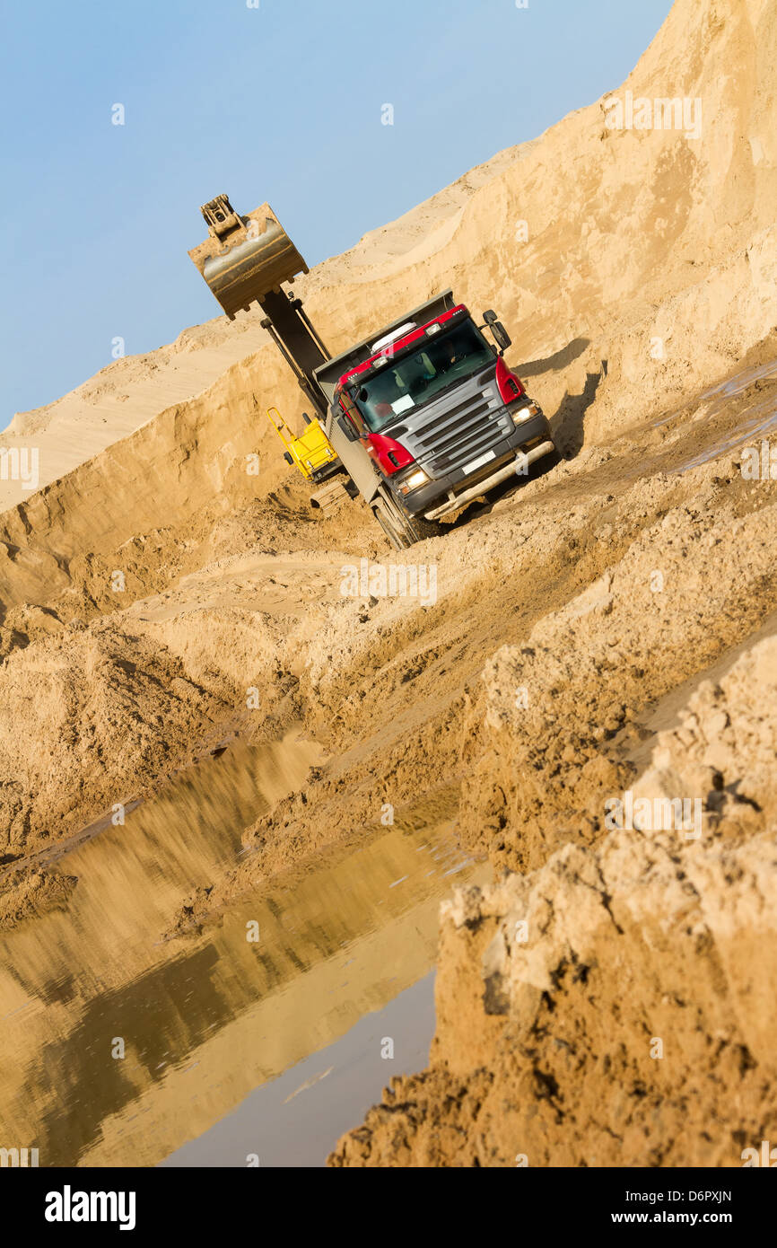 Excavator Loading Dumper Truck Stock Photo - Alamy