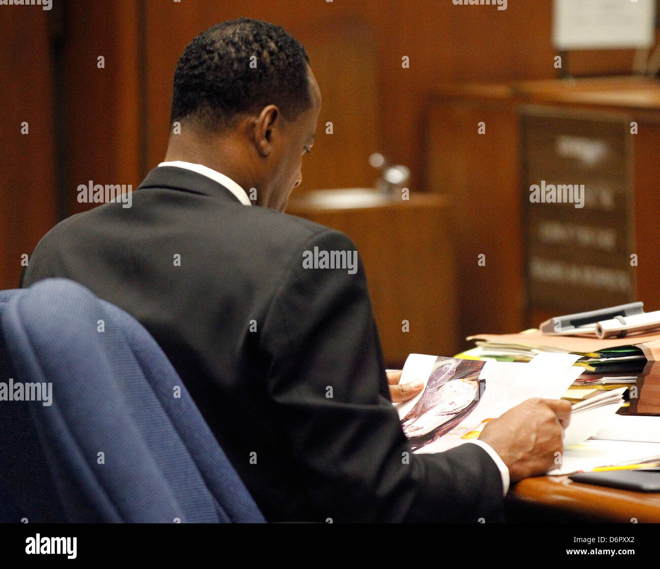 Dr.Conrad Murray looks at evidence photos duringhis trial in the death ...