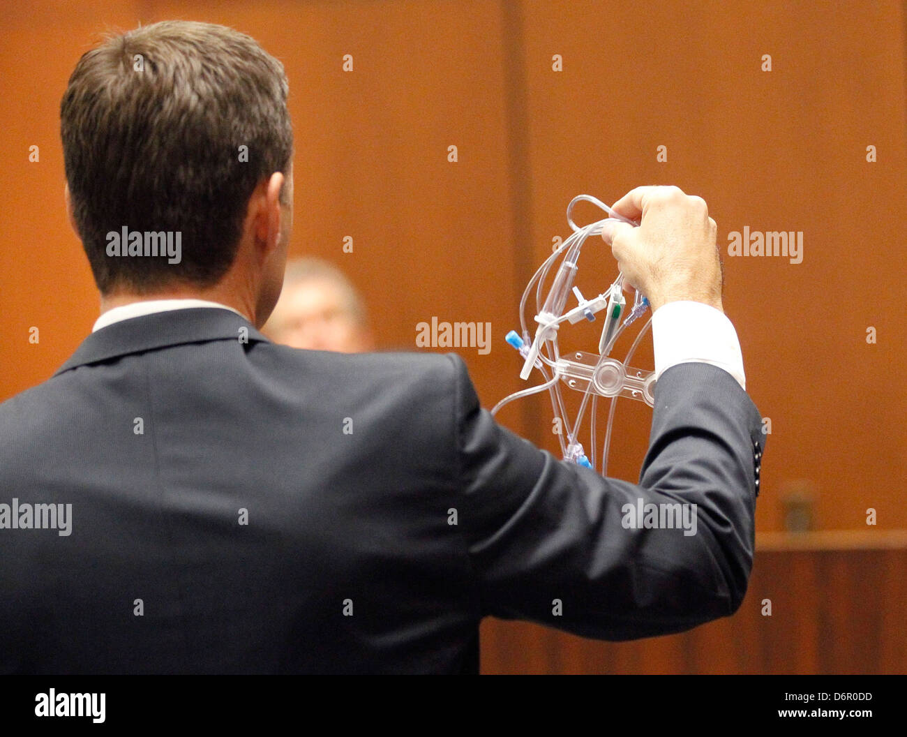 Deputy district attorney Davids Walgren shows an IV line to the court ...