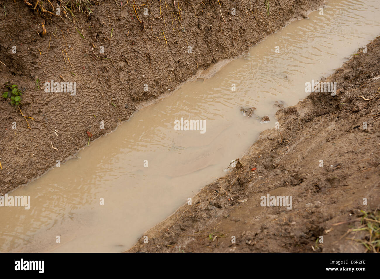 Natural drain away cut out of soil at the edge of farmland Stock Photo ...