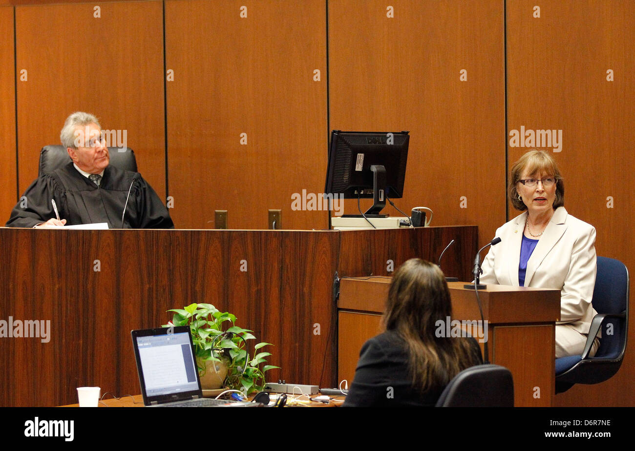 Judge Michael E. Pastor (L) listens as prosecution witness Dr. Joanne ...