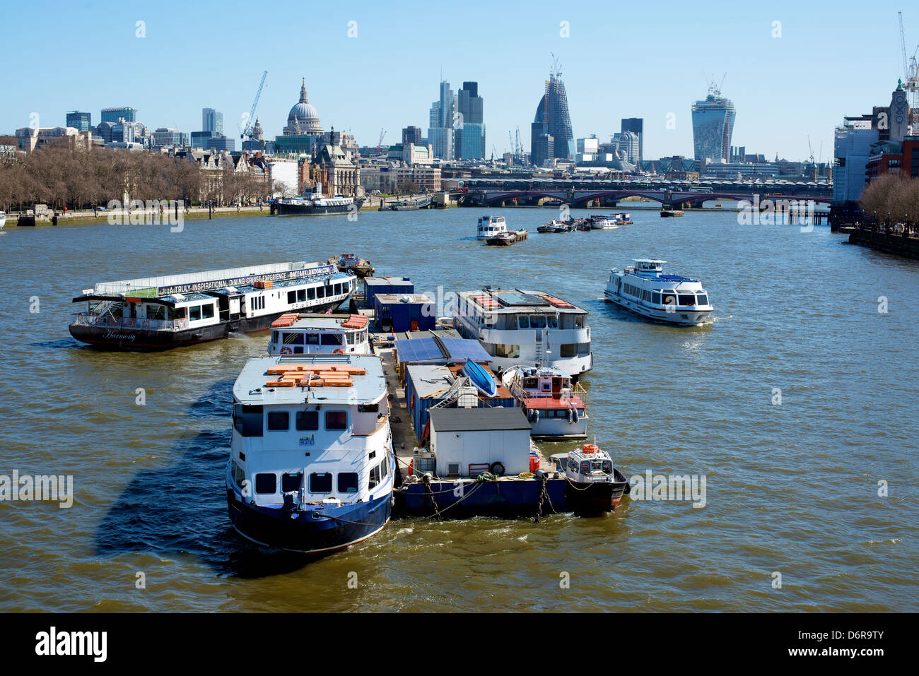 The River Thames busy with water traffic and St Paul's Cathedral and ...