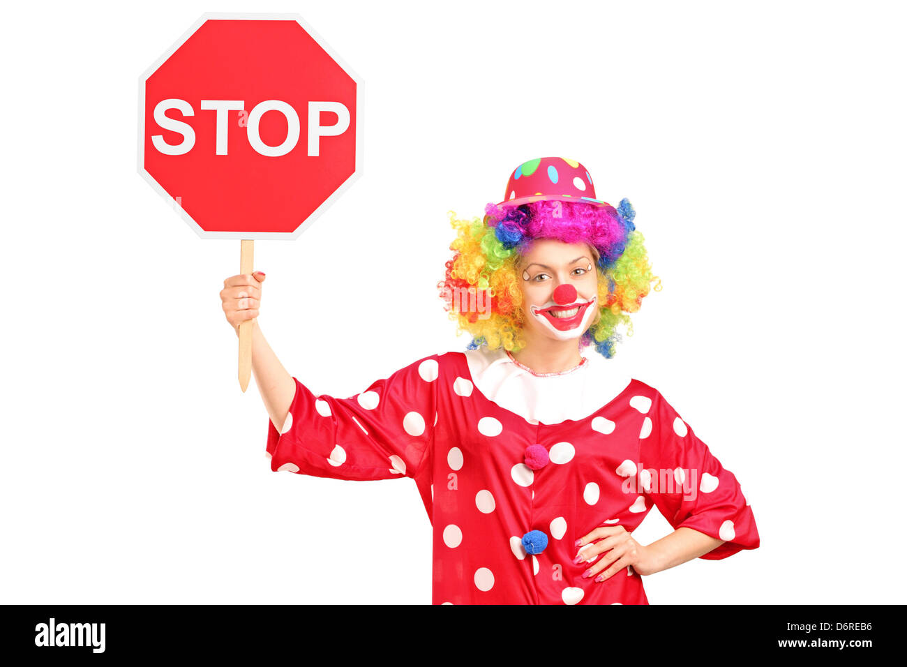 A clown holding a stop sign isolated against white background Stock ...