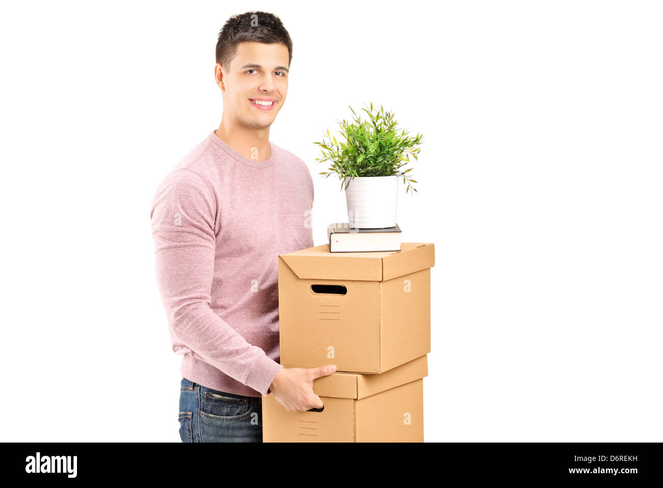 A young man carrying removal boxes isolated on white background Stock ...
