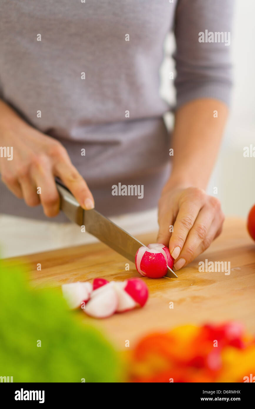 Closeup on woman cutting radishes Stock Photo - Alamy