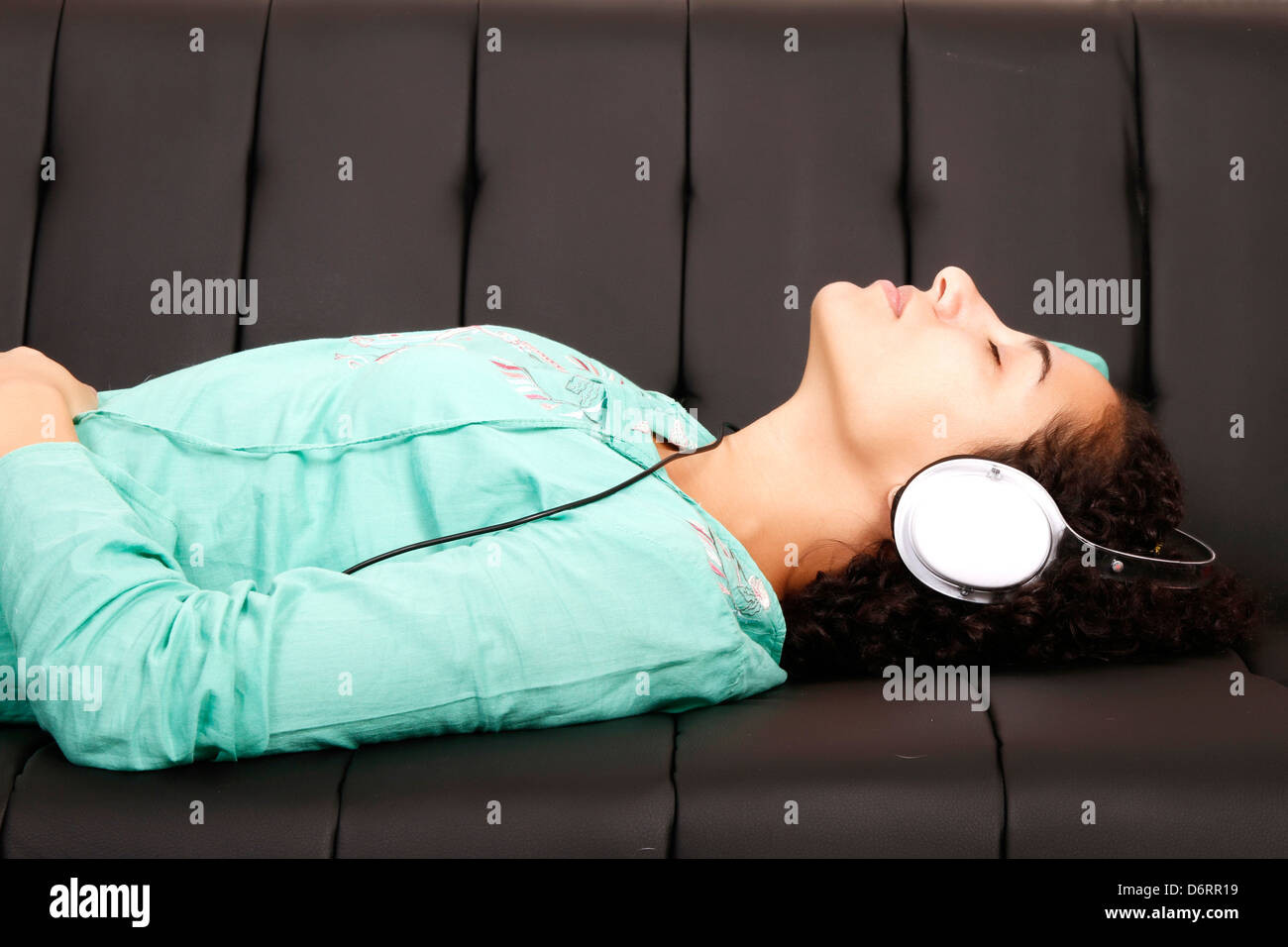 A jung brazilian woman relaxing on the sofa Stock Photo - Alamy
